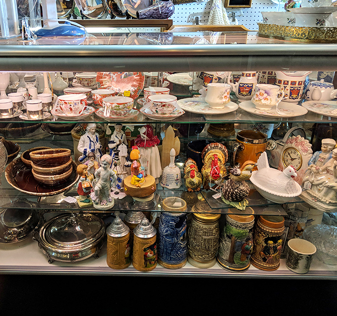 Delicate teacups and sturdy steins share shelf space like unlikely roommates, each with stories from different dinner tables across time.