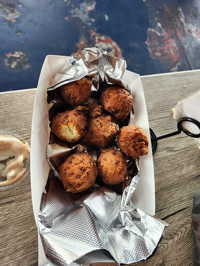 Golden-brown conch fritters that crunch like your favorite childhood memory before giving way to tender, flavorful bites of the sea.