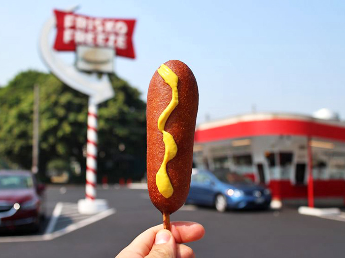 The humble corn dog, elevated to art form. That perfect mustard zigzag is the yellow brick road to happiness.