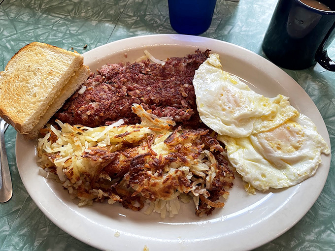 Corned beef hash with eggs sunny-side up—the breakfast equivalent of hitting the jackpot on your first pull.