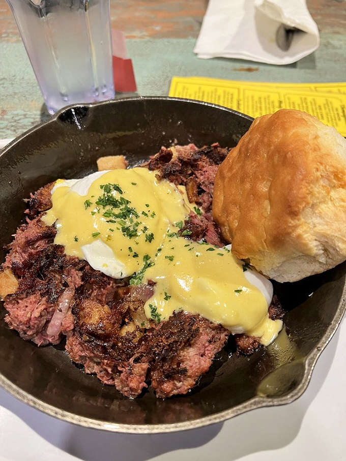 Corned beef hash topped with poached eggs and hollandaise in cast iron&mdash;deli meets diner in the most delicious way.
