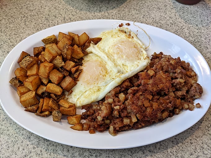Breakfast of champions: home fries crisped to perfection, eggs sunny-side up, and corned beef hash that would make your cardiologist wince but your soul sing.