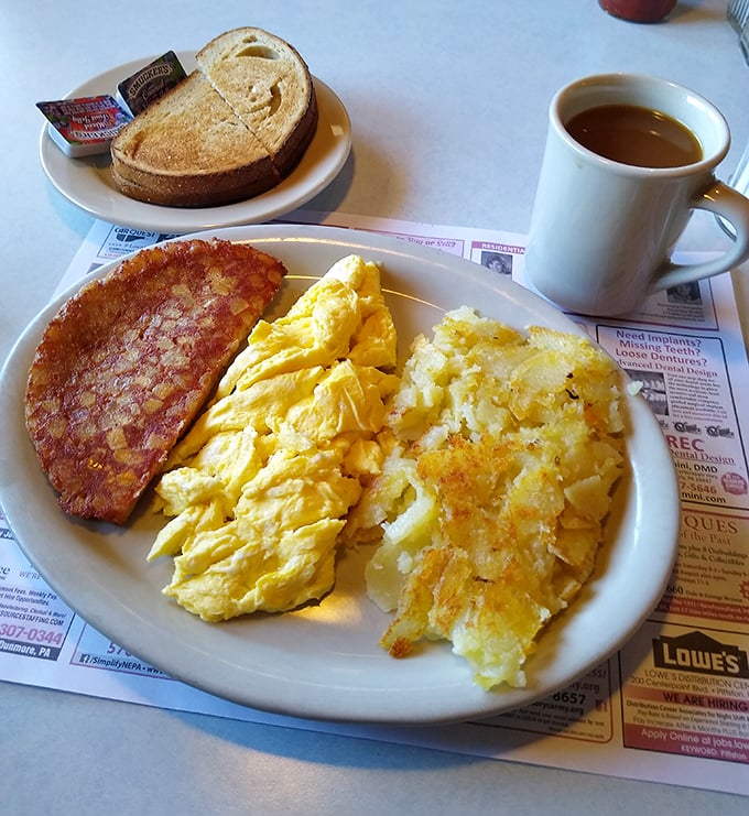 The breakfast trinity: perfectly scrambled eggs, crispy home fries, and ham that would make any pig proud to have made the sacrifice.