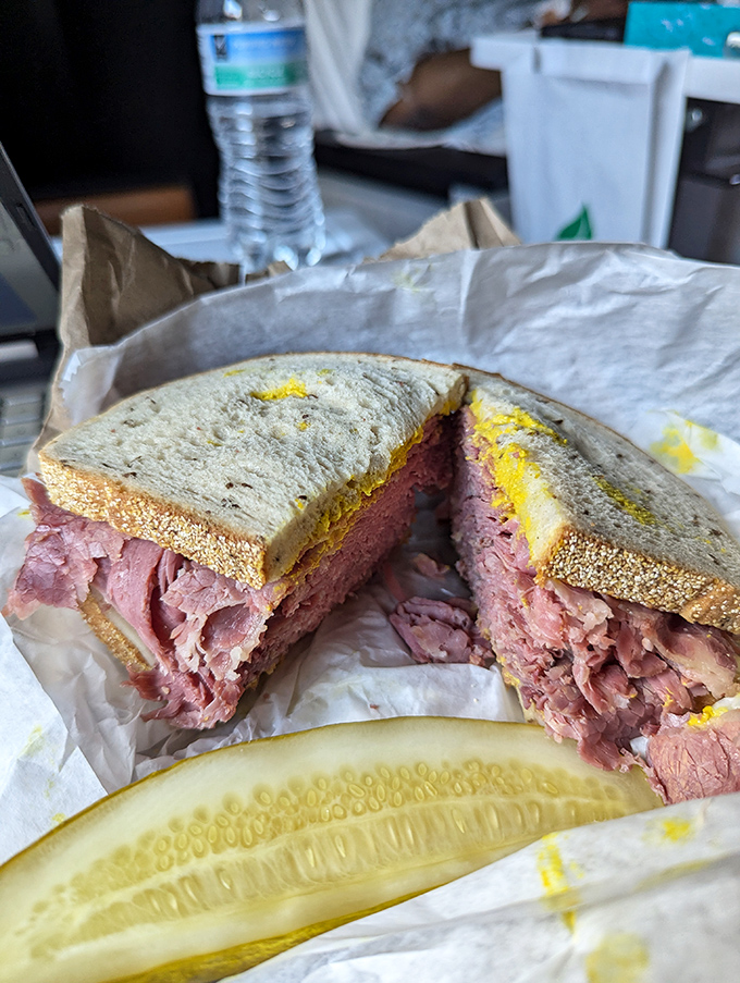 The star of the show: a corned beef sandwich so generously stuffed it requires an engineering degree to eat without creating a delicious disaster.