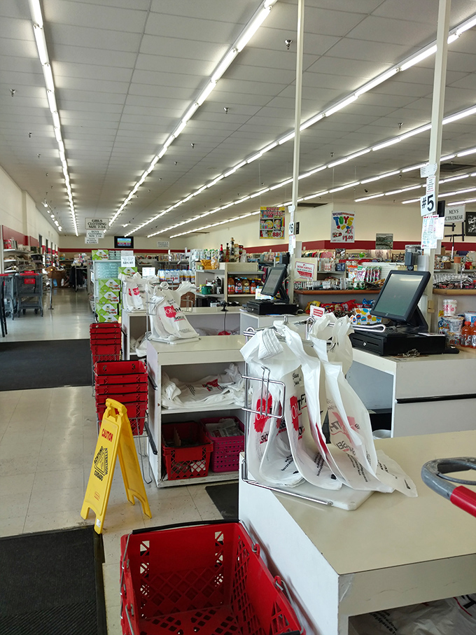The checkout area stands ready for triumphant thrifters, those red baskets soon to carry someone's newfound treasures home.