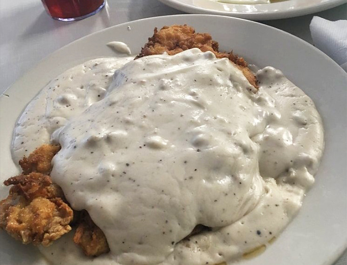 Country fried steak swimming in creamy pepper gravy &ndash; the kind of dish that makes you want to hug the cook and then take a very satisfied nap.