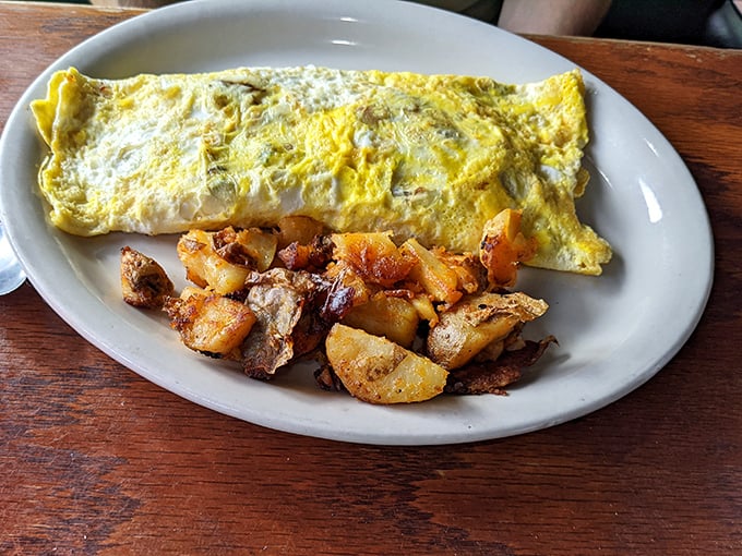 An omelet that doesn't just sit on the plate&mdash;it commands attention with its perfect fold and generous filling, like a letter from breakfast heaven.