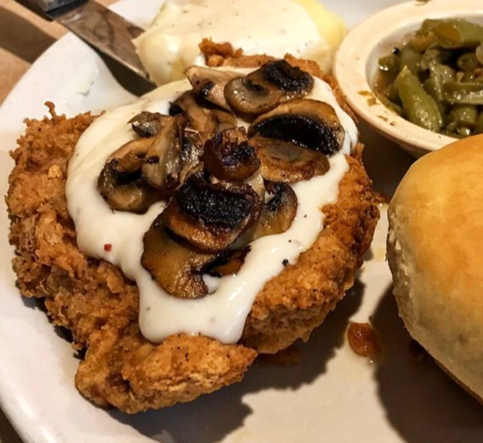 Country fried pork chop wearing its gravy and mushroom crown like royalty. The side of green beans is just pretending to make this healthy.