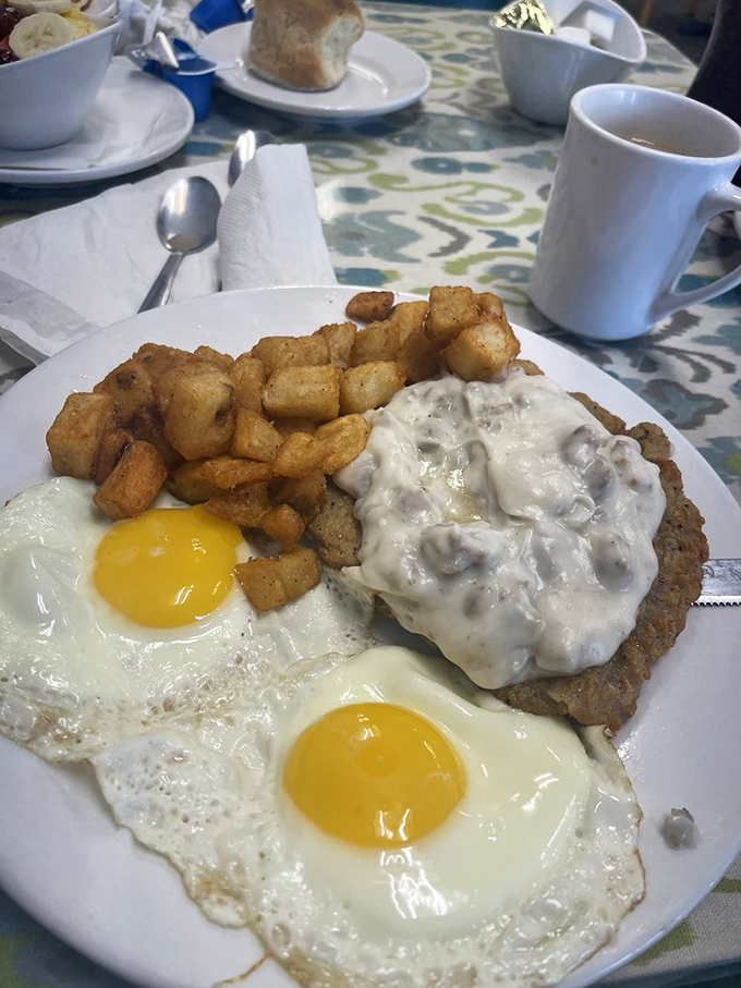Country fried steak smothered in gravy with a side of golden home fries – the breakfast equivalent of a warm hug from your favorite aunt.