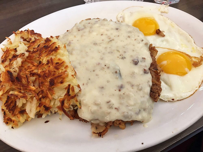 Country fried steak smothered in gravy with sunny-side-up eggs standing guard. Heart attack on a plate? Worth every delicious risk.