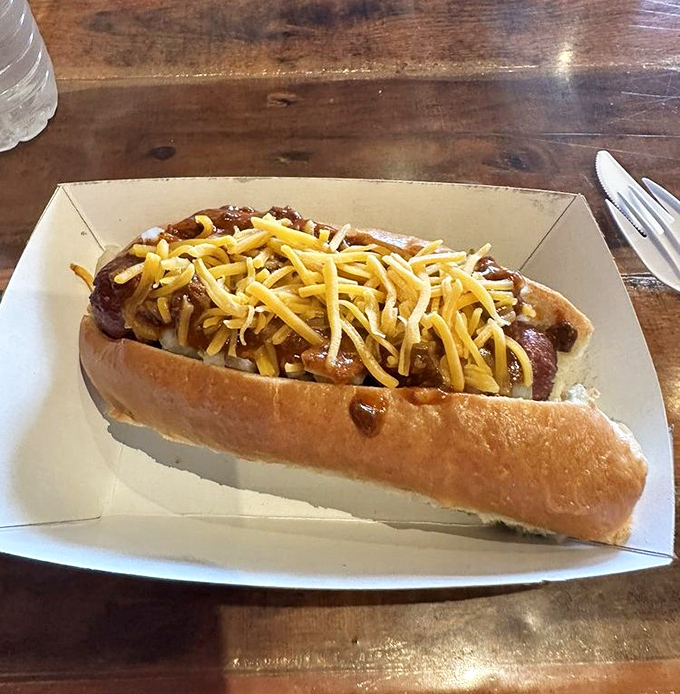 Chili and cheese cascade over this Cowboy Dog like a delicious sunset. The soft bun cradles its hearty contents with the tenderness of a lullaby.