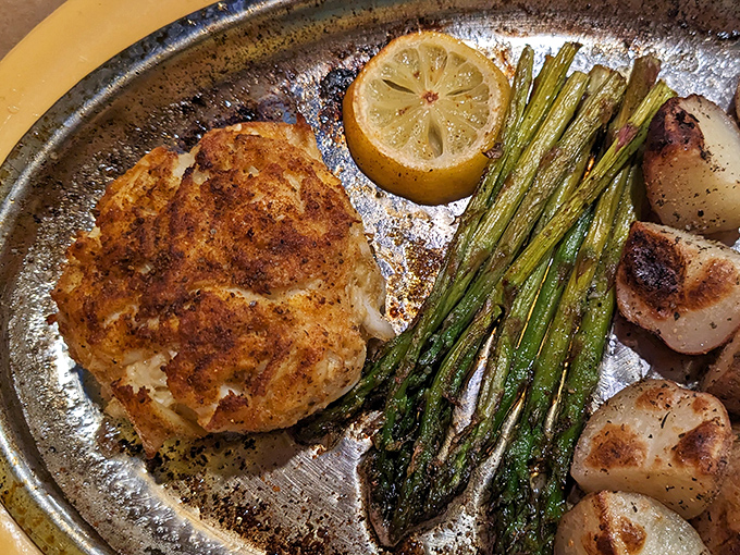 This isn't just a crab cake&mdash;it's Maryland's soul on a plate. Golden-brown perfection with asparagus standing at attention alongside.