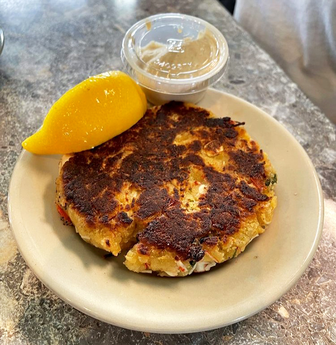 Seafood alchemy at work. This golden-brown crab cake showcases the kitchen's respect for fresh ingredients&mdash;minimal filler, maximum flavor.