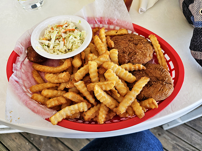 The legendary crab cakes in their natural habitat&mdash;golden-brown discs of mostly-crab-minimal-filler heaven flanked by crispy curly fries.