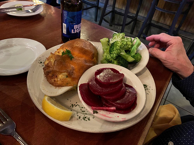 A perfectly broiled crab cake with sides of broccoli and beets. The holy trinity of Maryland dining: sweet crab, fresh vegetables, and cold beer.