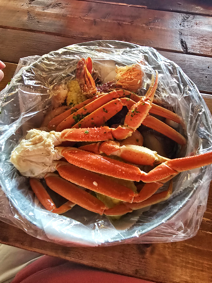 Snow crab legs splayed like a sunburst of oceanic treasure. The plastic bag isn't fancy, but what's inside is pure seafood royalty.