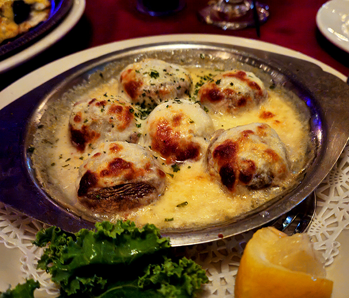 These aren't just mushrooms &ndash; they're little boats of happiness sailing on a sea of melted cheese. Comfort food elevated.