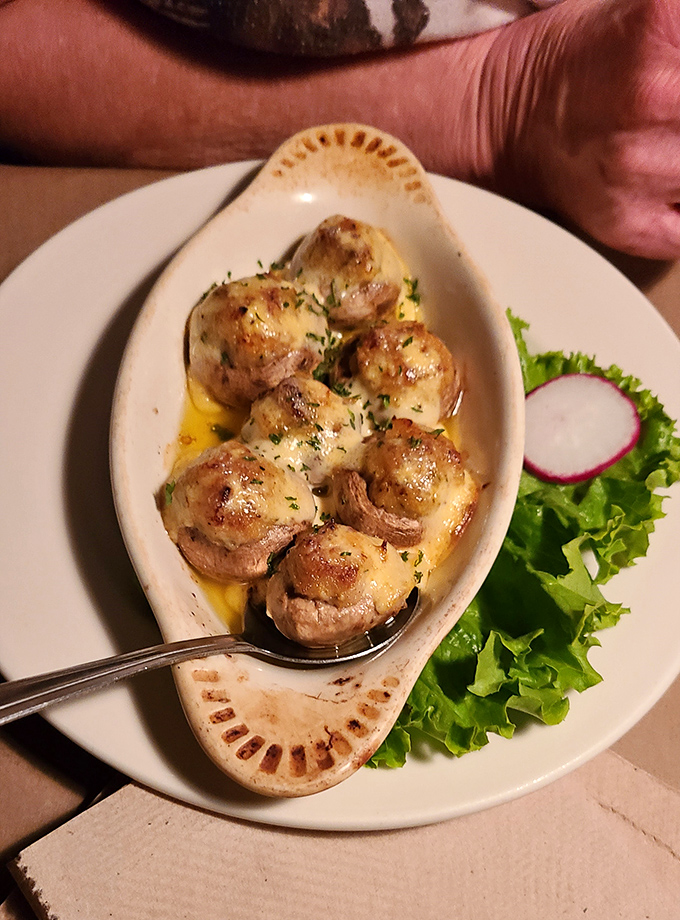 These aren't just stuffed mushrooms&mdash;they're little boats of joy sailing through butter seas. The kind of appetizer that ruins your appetite because you can't stop ordering more.