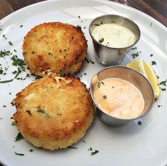 These crab cakes aren't playing around &ndash; packed with sweet crab meat, perfectly golden-crusted, and served with two complementary sauces for maximum flavor exploration.