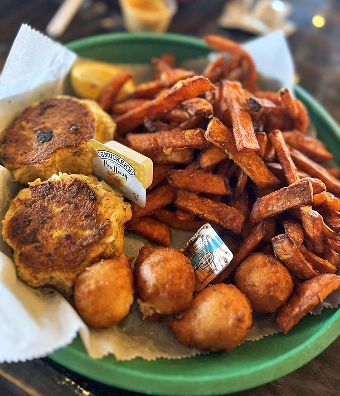 Those crab cakes are bronzed beauties flanked by sweet potato fries, proving that sometimes the best meals are the ones that look this good.