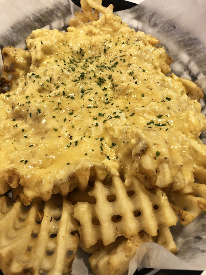 Golden crab fries swimming in cheese sauce&mdash;proof that sometimes the best battlefield strategy is "death by deliciousness."