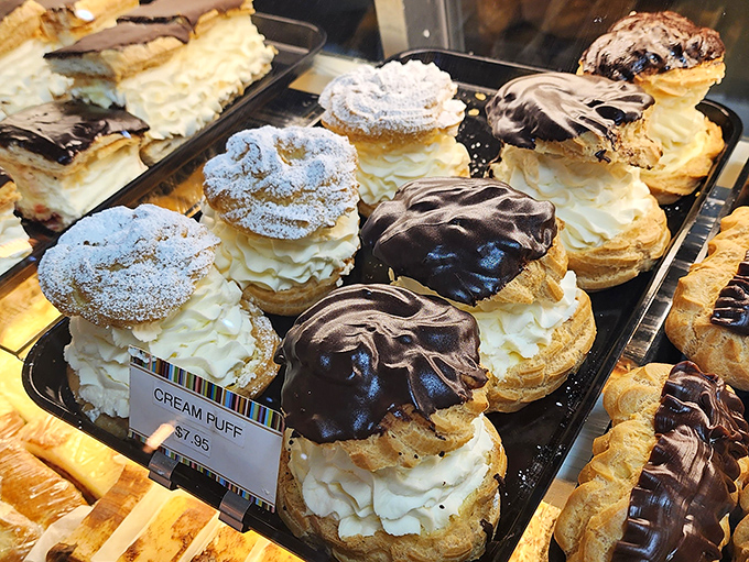 Cream puffs wearing chocolate hats and powdered sugar bow ties &ndash; part dessert, part fashion statement, all delicious. Coco Chanel would approve.
