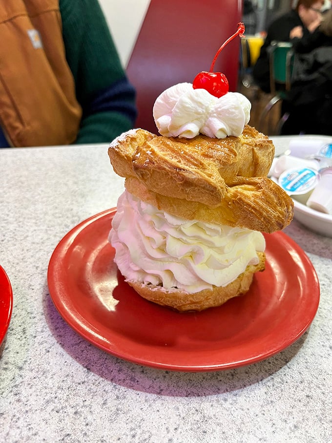 This cream puff tower with its cherry on top laughs in the face of portion control and dietary restraint.