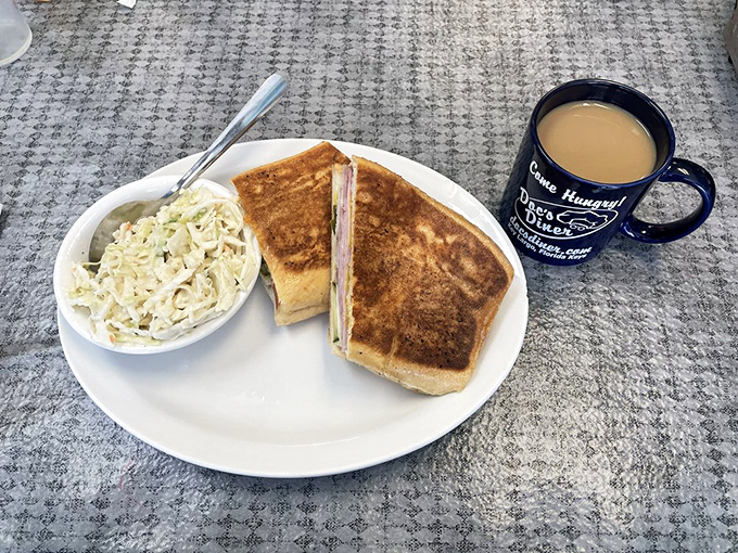 A proper diner sandwich with coleslaw on the side and that signature black mug promising unlimited coffee refills – lunch nirvana achieved.