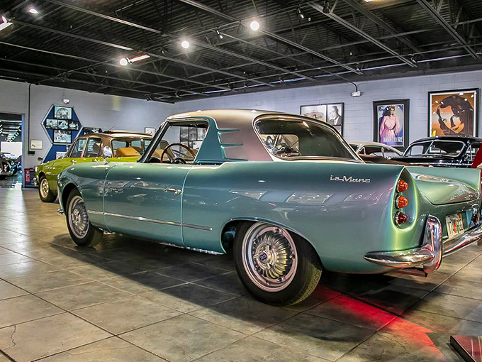The minty-fresh Deutsch Bonnet Le Mans sports car gleams under museum lights. Its aerodynamic curves whisper secrets of wind tunnels and speed trials.