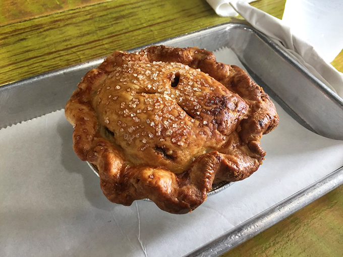 Some pies change your day. This dark chocolate pecan pie might change your entire worldview. The glistening top promises secrets only your taste buds can decode.