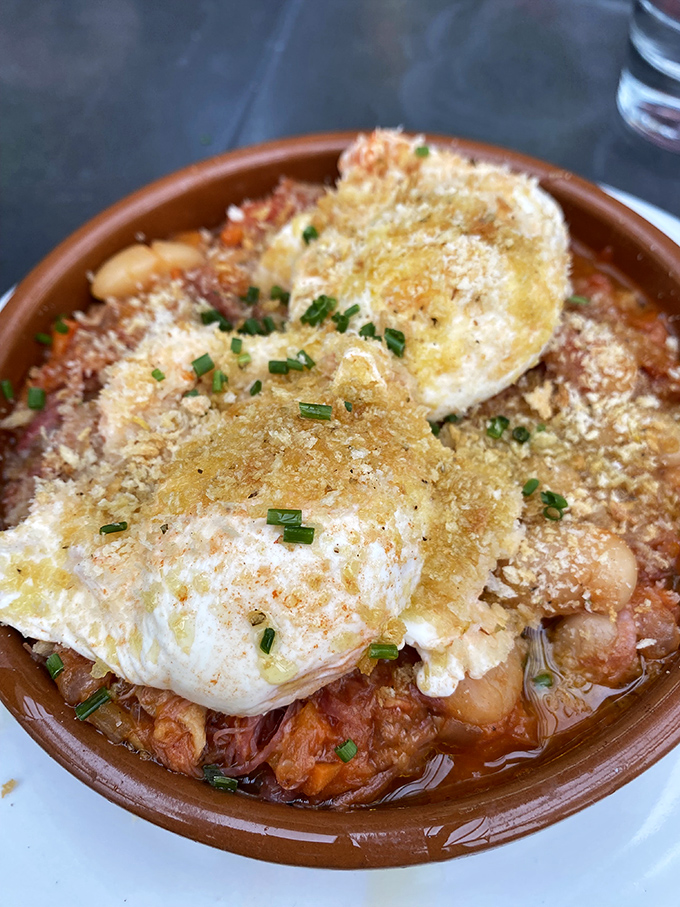 Eggs perched atop a bubbling stew like tiny suns rising over a delicious landscape. Comfort food that hugs you from the inside.