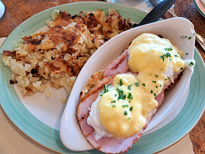 Eggs Benedict: where hollandaise sauce cascades over Canadian bacon and poached eggs like a yellow waterfall of breakfast bliss.