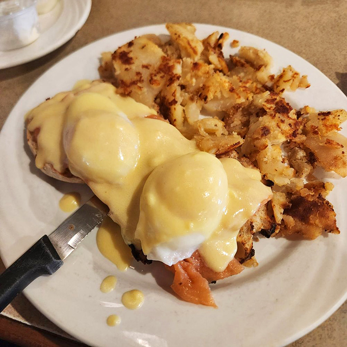 Eggs Benedict done right &ndash; poached eggs perched atop their English muffin throne, draped in hollandaise and served with perfectly crispy home fries.