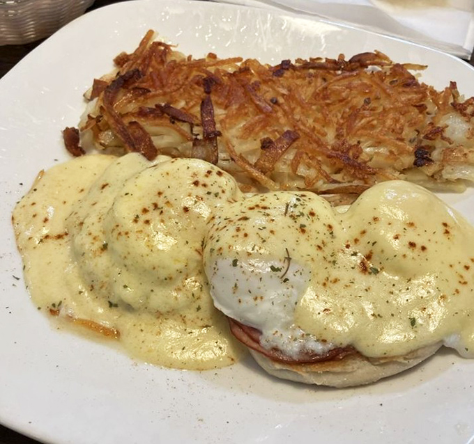 Eggs Benedict that would make a breakfast purist weep with joy, paired with hash browns crisped to golden perfection.