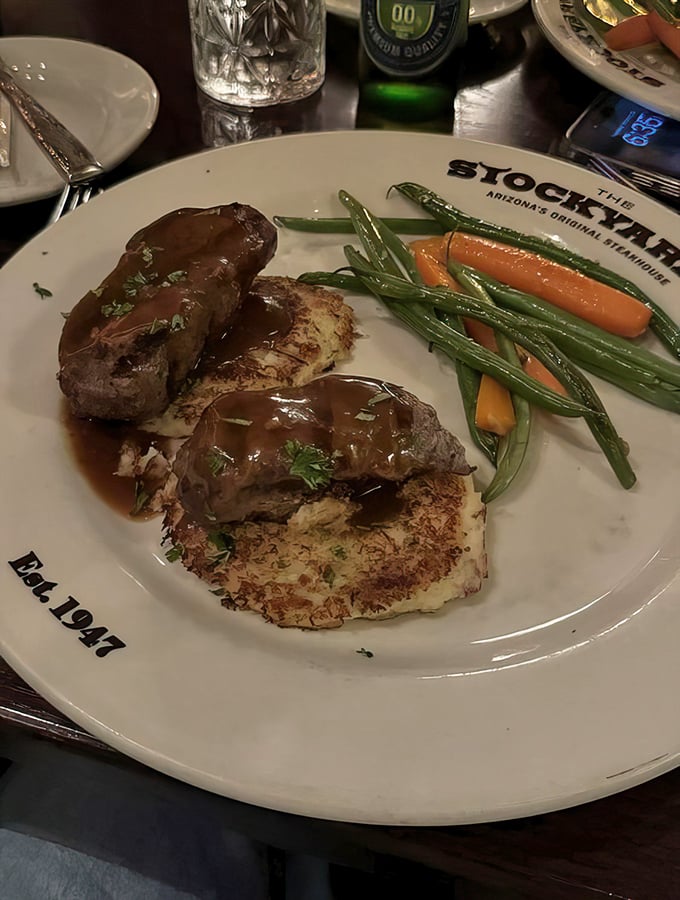 Elk medallions resting on potato pancakes&mdash;proof that sometimes the best culinary experiences come from ingredients that once had antlers.
