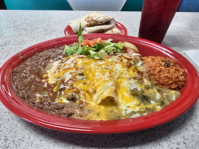 Christmas came early &ndash; red and green chile blanketing these enchiladas like a spicy security blanket for your taste buds. New Mexico's gift to humanity.