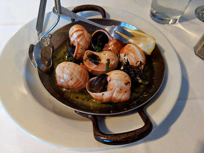 Escargot swimming in buttery goodness &ndash; proof that sometimes the most delicious things come in the most humble packages.