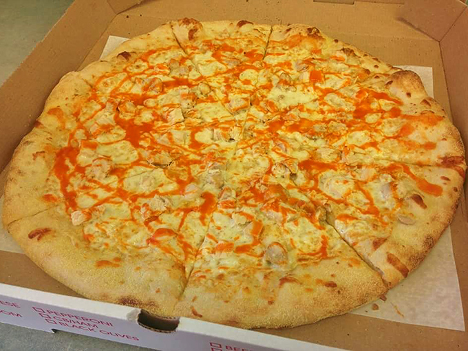 That orange drizzle isn't just for show&mdash;it's the signature buffalo sauce that transforms this pie from dinner to DelCo legend.