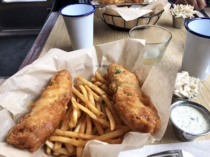 Fish and chips that would make a British pub-goer homesick. The batter shatters like glass, revealing steamy, flaky white fish beneath.