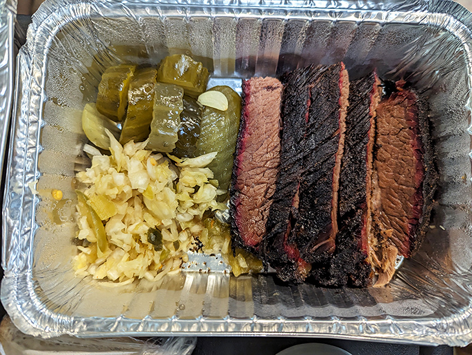 Behold the brisket trifecta &ndash; each slice sporting that coveted pink smoke ring like a badge of barbecue honor.