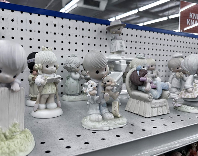 Precious Moments figurines frozen in perpetual cuteness, silently judging your other purchases from their perch on the collectibles shelf.