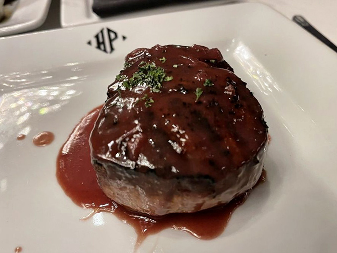 This filet mignon doesn't just sit on the plate &ndash; it commands attention with its glistening sauce and perfect doneness that whispers, "You've made an excellent decision."