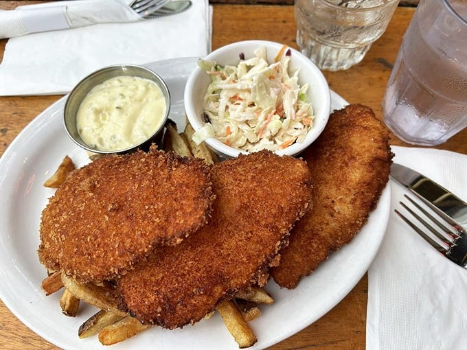 Golden-fried fish that would make a British pub jealous, served with crispy fries and coleslaw that actually deserves to be eaten, not pushed aside.