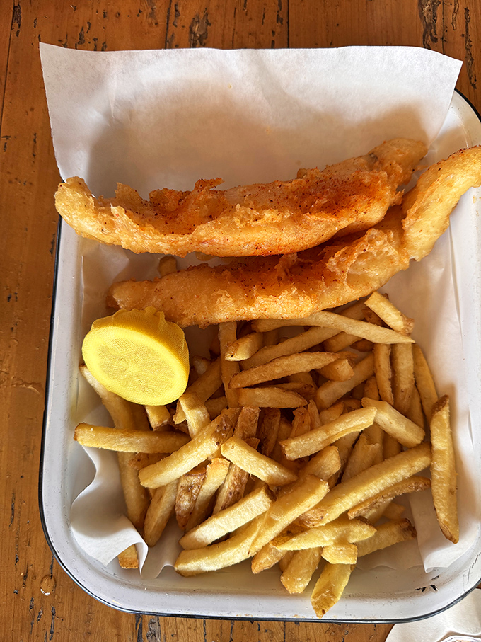 Fish and chips that actually crunch when you bite them—a rarity that deserves its own parade. The lemon wedge isn't just garnish; it's essential equipment.