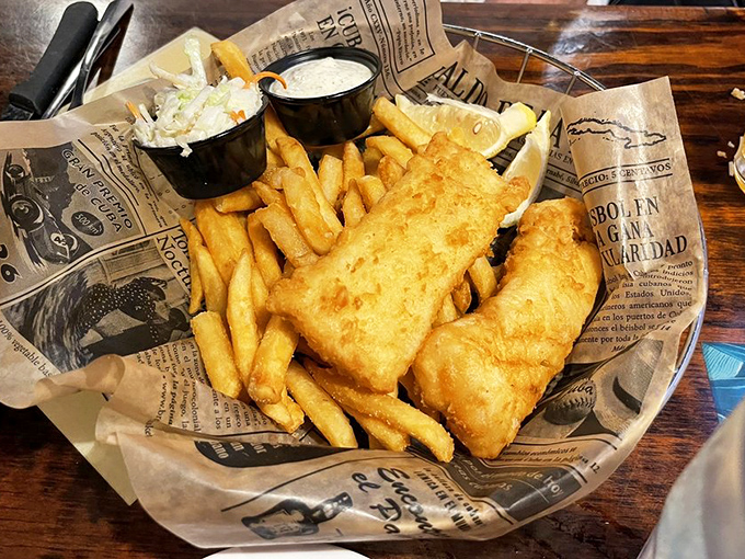 Fish and chips done right&mdash;crispy, golden batter protecting flaky white fish, served on newspaper because some traditions are worth keeping.