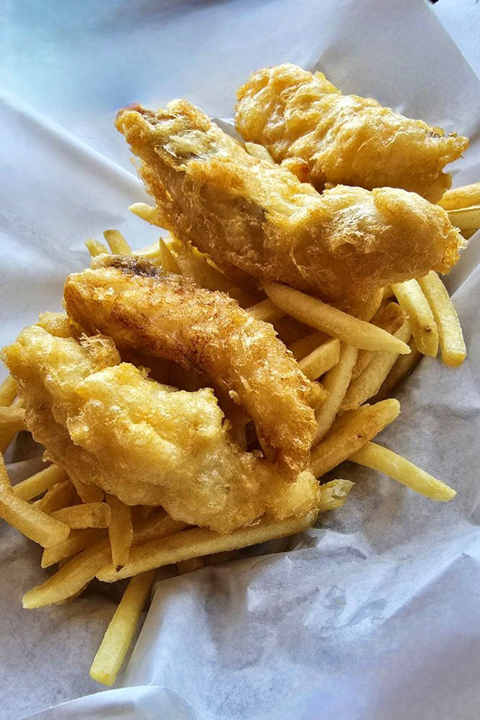Golden battered perfection that proves coastal location means fresh fish done right every time.