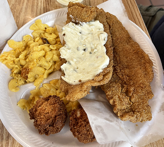 Southern-fried perfection on a plate. That cornmeal crust deserves its own fan club, while the mac and cheese plays a delicious supporting role.