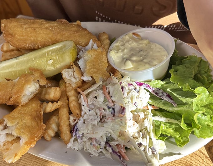Fish and chips that would make a British pub jealous, with coleslaw playing the perfect supporting role.