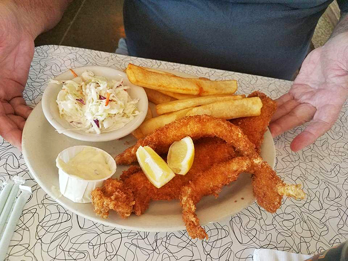 Crispy fish fillets with a golden crust that would make Neptune himself swim to shore, served with coleslaw and fries for the full diner experience.