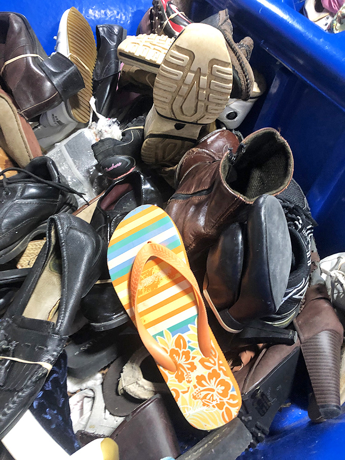 The footwear bin—where hiking boots, dress shoes, and beach flip-flops mingle like strangers at the world's most democratic cocktail party.